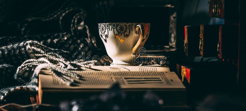 Panoramic Closeup Shot of a Small Tea Cup on an Open Book with a ...