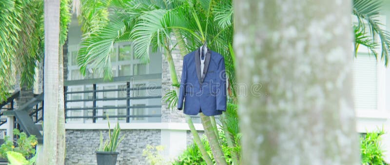 Panoramic Footage of a Blue Wedding Suit Hanging on a Tree in the ...