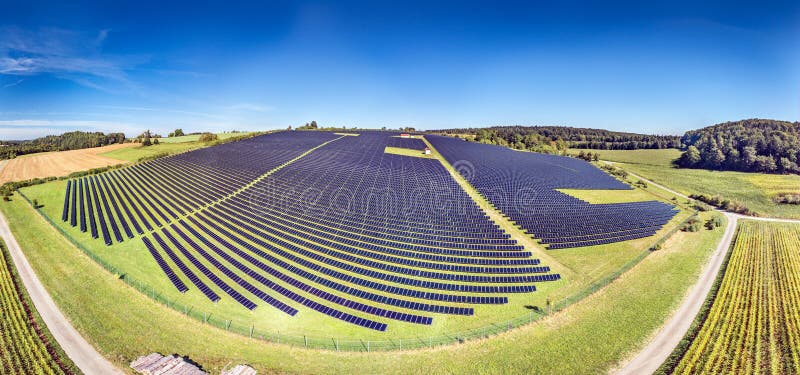 Panoramic Image of a Large Solar Field on a Green Meadow in Daylight ...