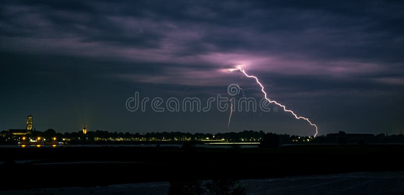 A High Voltage Lightning Bolt Strikes Down To Earth from the Upper ...