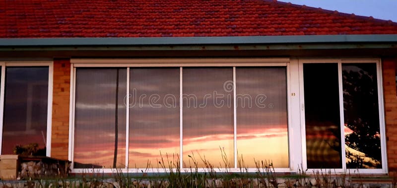 Panoramic Shot of a Beautiful Sunset Reflected in the Windows of a ...