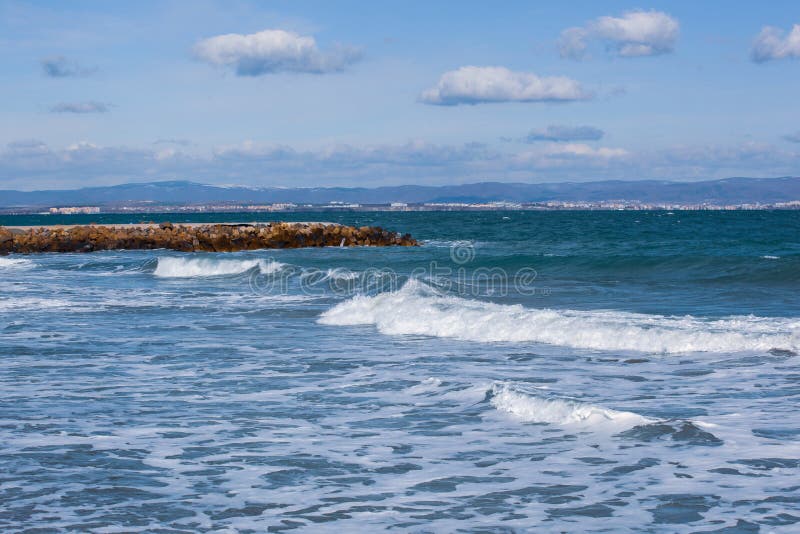 Panoramic Shot of an Ocean with Rolling Waves and Stone Dock Under ...