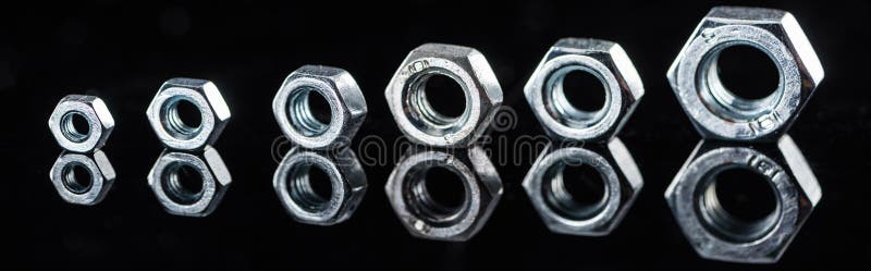 Panoramic Shot of Shiny New Metallic Nuts Isolated on Black. Stock ...