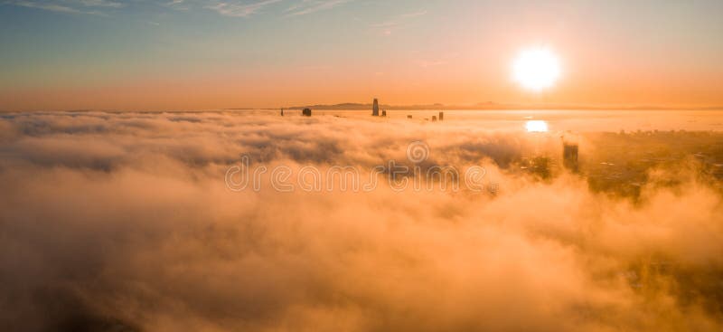 Panoramic Shot of the Sunrise Over the Clouds with Skyscrapers Rising ...