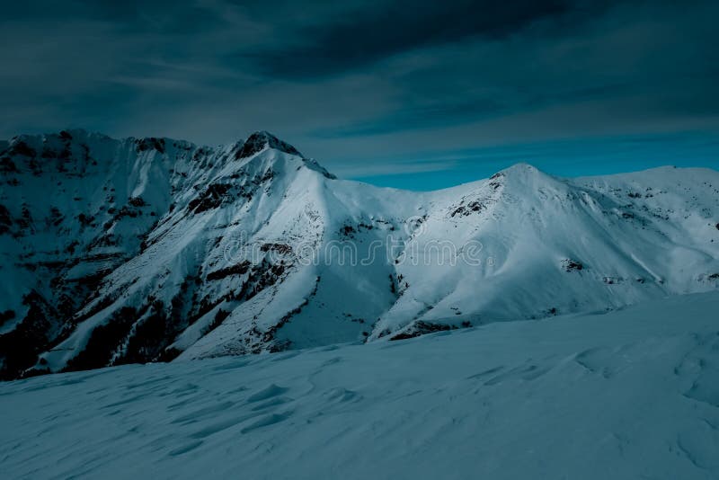 Panoramic Shot on Top of a Snow Covered Mountain Under Cloudy Skies ...