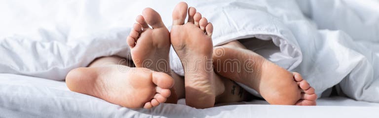 Panoramic Shot of Two Barefoot Lesbians Lying Under Blanket. Stock ...