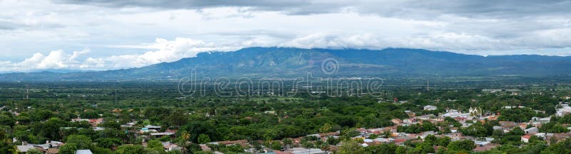 Panoramic Shot of a Village Covered in Trees with High Hills in the ...