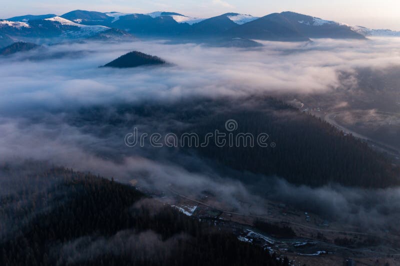 A Panoramic View from Above of the Mountain Peaks in Thick Clouds ...
