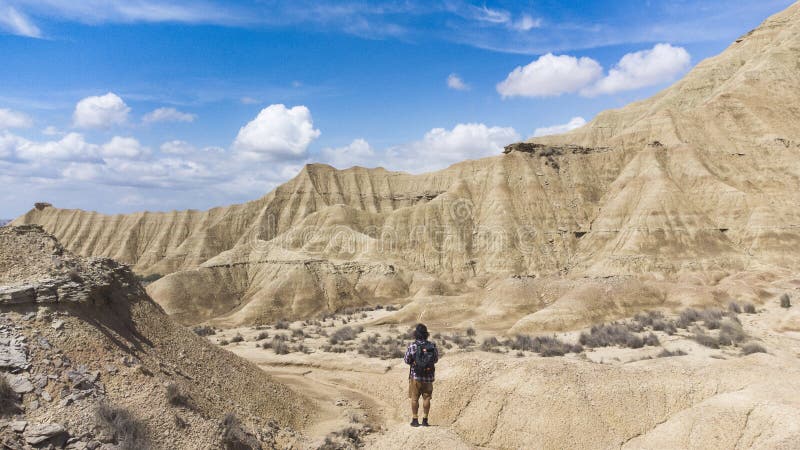 Panoramic View of the Colored Stone Desert and Traveler on His Back ...