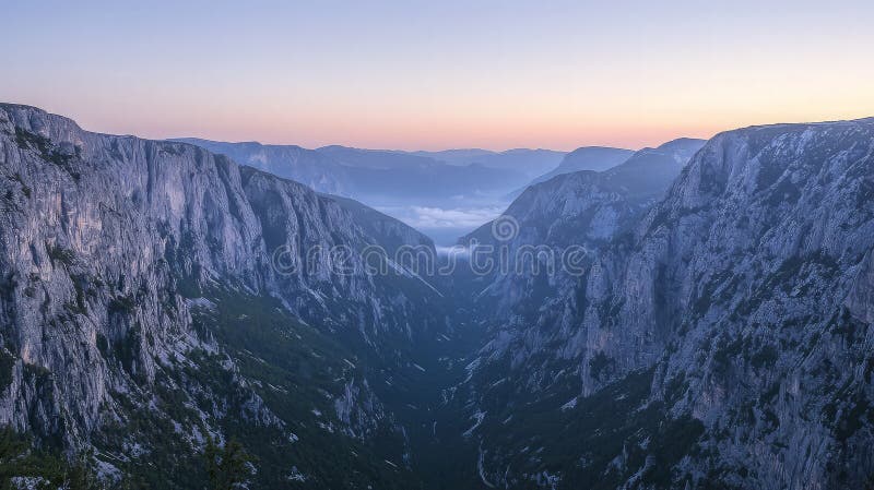 A Panoramic View of a Deep Valley with Steep, Rocky Cliffs on Both ...