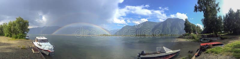 Panoramic View on Double Rainbow Above River with Mountains and Cloudy ...
