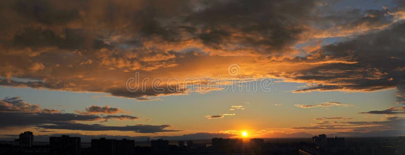 A Panoramic View of the Evening Sky and Clouds Over the City Rooftops ...