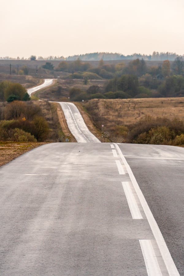 Panoramic View of a Long Empty Asphalt Road in a Hilly Area. the Empty ...