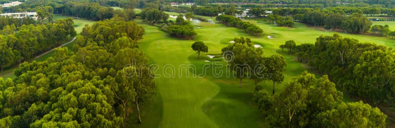 A Panoramic View of a Lush Golf Course Surrounded by Greenery and Trees ...