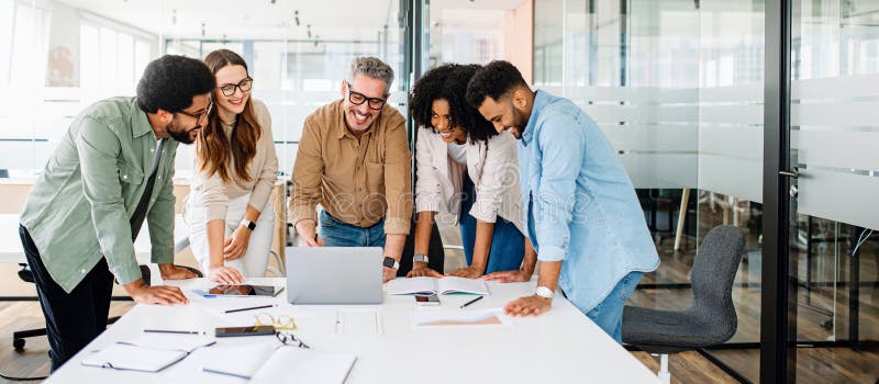 A Panoramic View of a Motivated Team Intensely Focused on a Computer ...