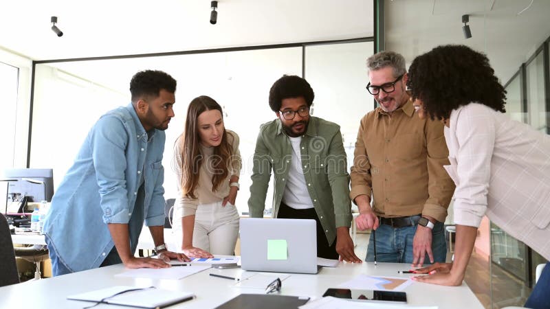 A Panoramic View of a Motivated Team Intensely Focused on a Computer ...