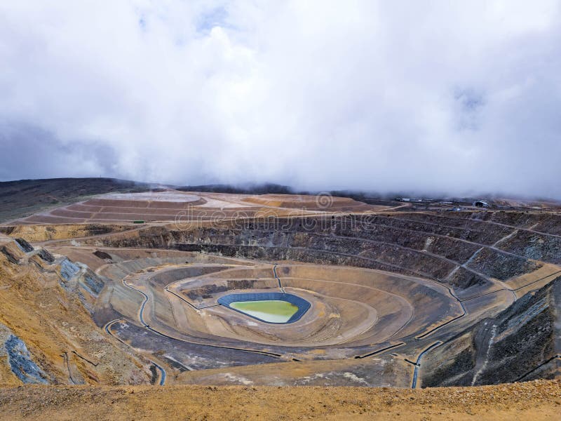 Panoramic View of an Open Pit Mine with a Lagoon in the Background and ...