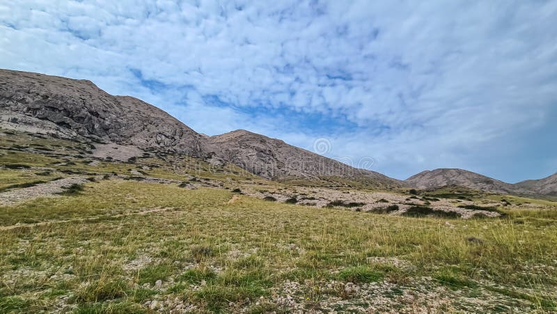 Panoramic View of Rolling Hills and Rugged Mountains Peaks Covered in ...