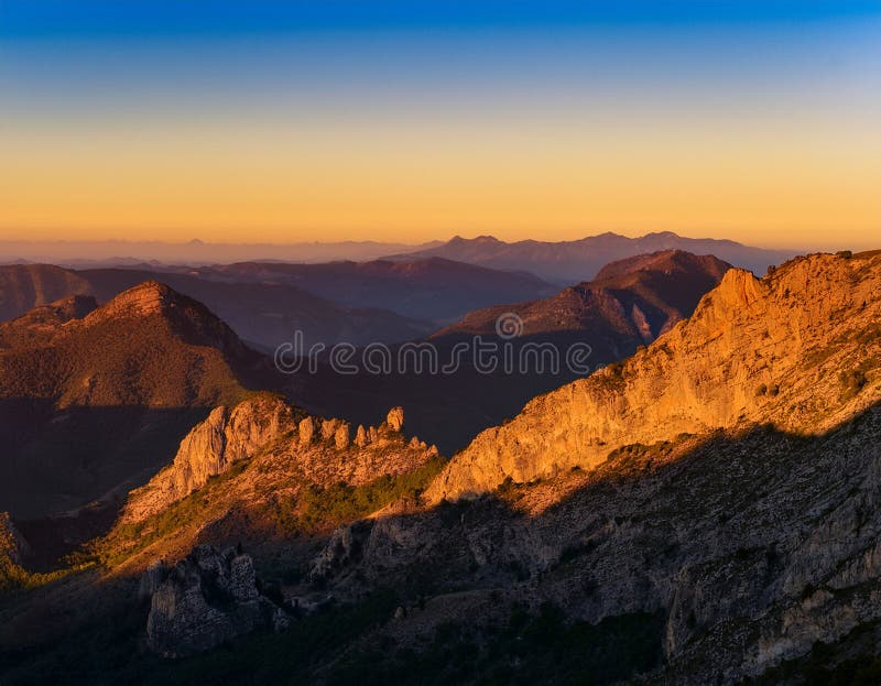 A Panoramic View of Spanish Mountain Ranges with Jagged Peaks Lit by ...