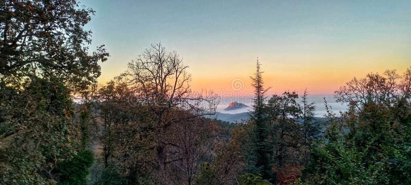 Panoramic View through Tree Branches on the Top of a Mountain Above the ...
