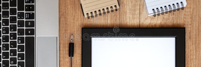 Panoramic View on a Wooden Desk with a Laptop, a Black Empty Frame and ...