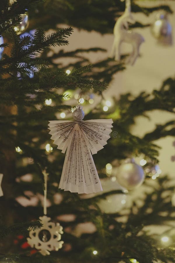 Paper Angel Atop a Christmas Tree with Festive Decorations Stock Image ...