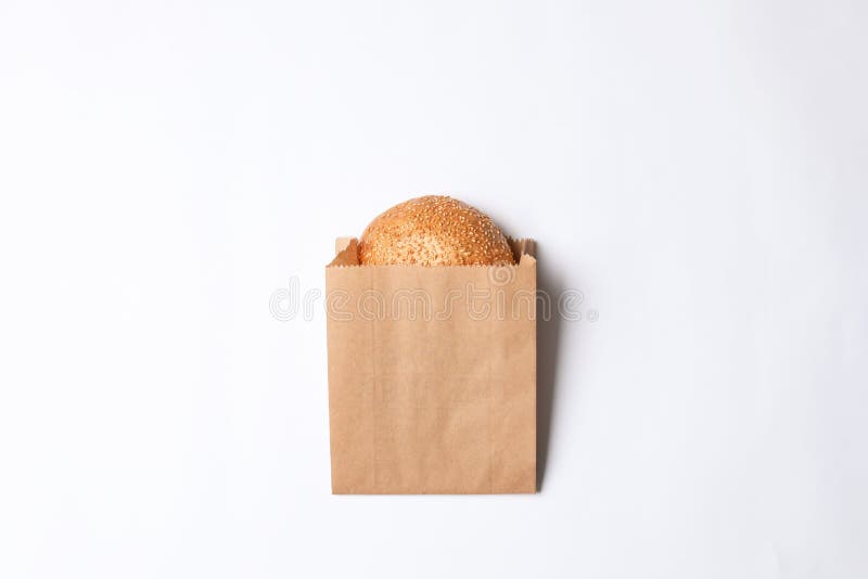 Paper Bag with Sesame Bun on White Background, Top View. Stock Photo ...