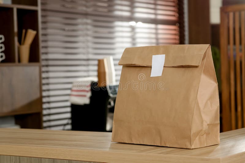 Paper Bag on Wooden Counter in Cafe, Space for Text Stock Photo - Image ...