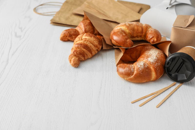 Paper Bags with Pastry and Takeaway Food on Light Table Stock Image ...