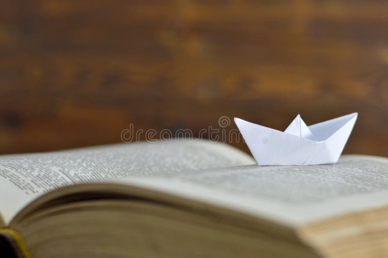Paper boat on the book stock photo. Image of adventure - 91744648