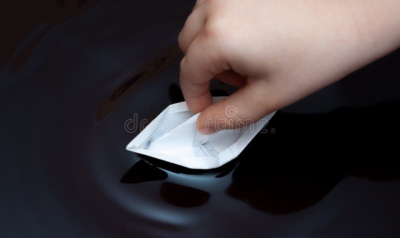 Paper Boat in the Dark Water Stock Photo - Image of float, hand: 214489494