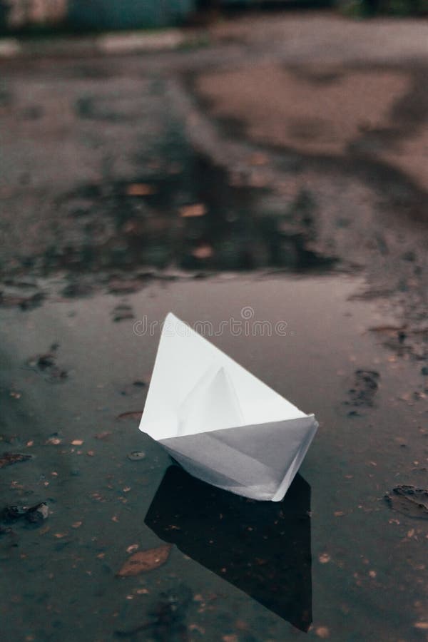 Paper boat on puddle stock image. Image of business - 178237841