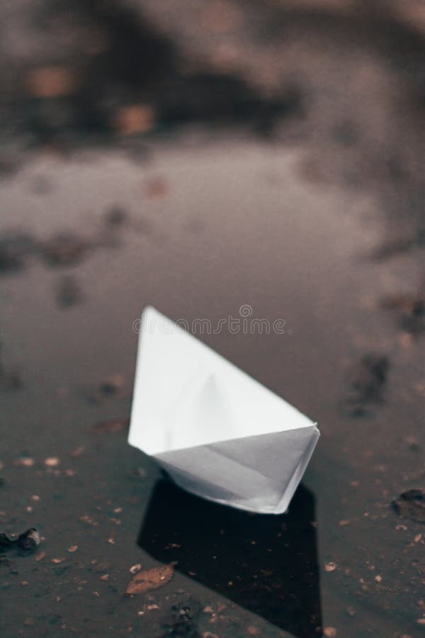 Paper boat on puddle stock image. Image of black, cash - 176816205