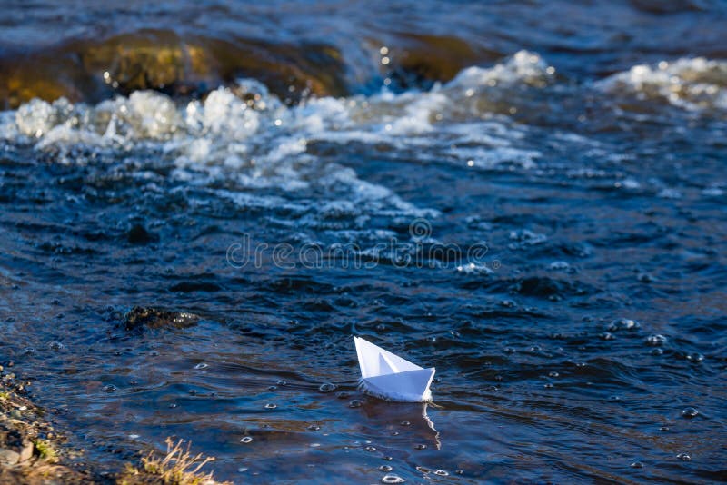 A Paper Boat on a Turbulent Stream of Water Struggles with the Flow ...