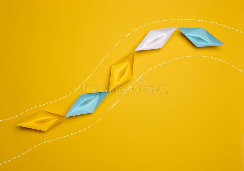 Paper Boats on a Yellow Background, Top View, Representing the Concept ...