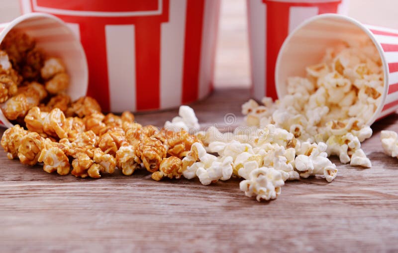Paper Buckets with Scattered Tasty Popcorn on Table Stock Photo - Image ...