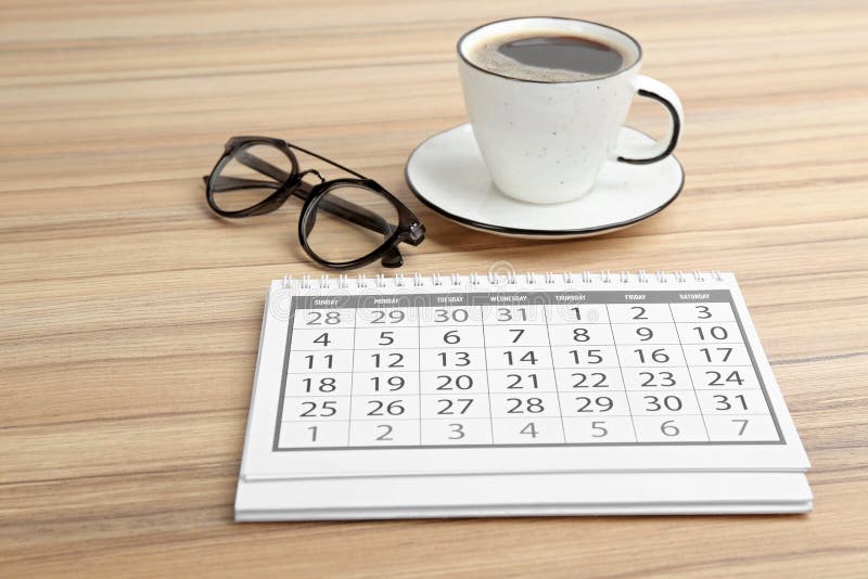 Paper Calendar, Cup of Coffee and Glasses on Table Stock Image - Image ...