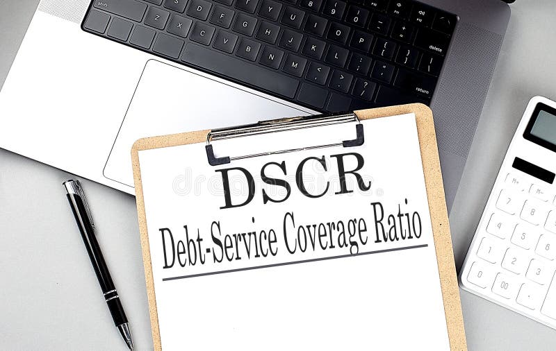 Paper Clipboard with DSCR Debt Service Coverage Ratio on Laptop with ...
