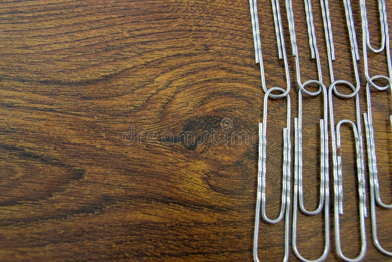 Paper clips on wood desk stock photo. Image of binder - 46597076