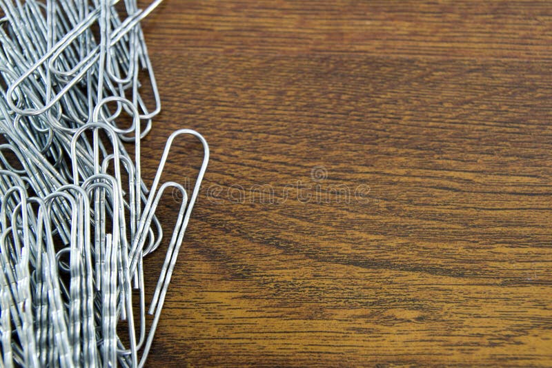 Paper clips on wood desk stock photo. Image of binder - 46597076