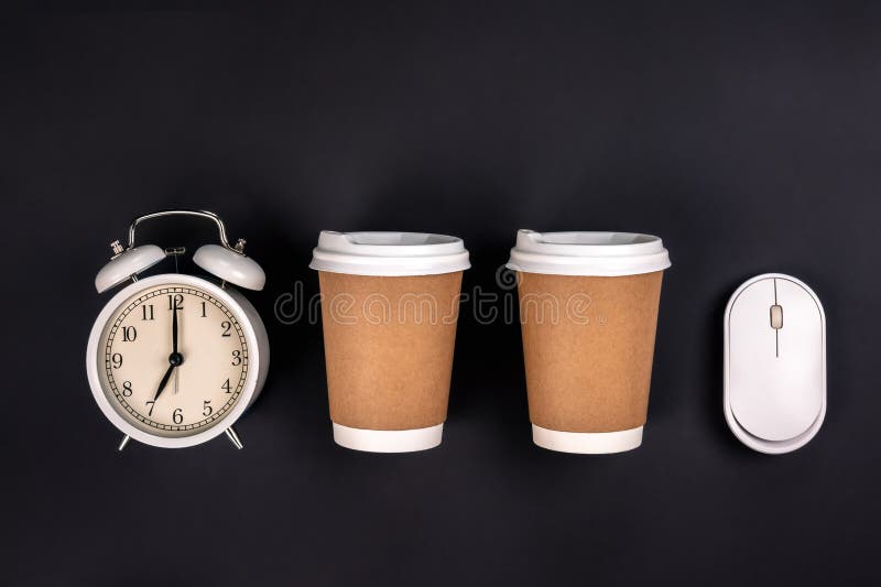 Paper Cups, Alarm Clock and a Computer Mouse on a Dark Background, Top ...