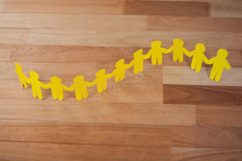 Paper Cut Outs Forming Human Chain Wooden Table Stock Photos - Free ...