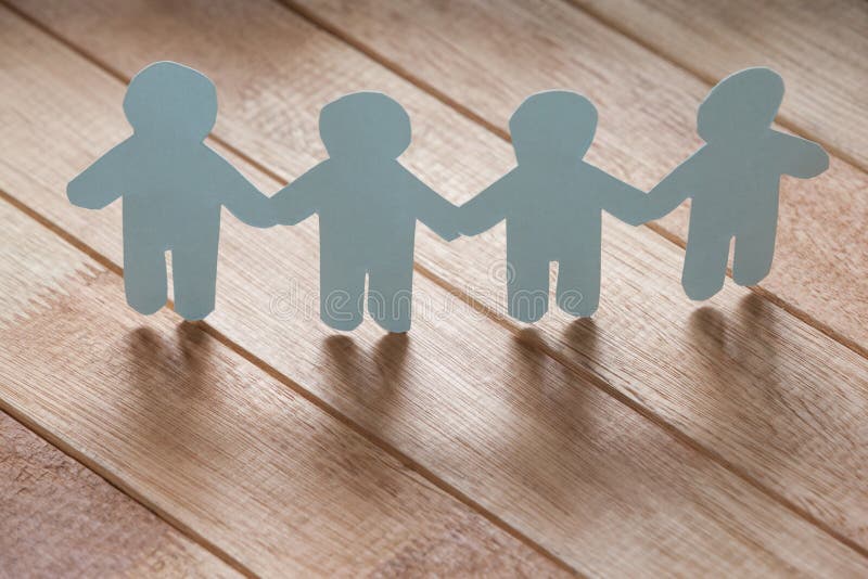 Paper Cut Outs Forming Human Chain Wooden Table Stock Photos - Free ...