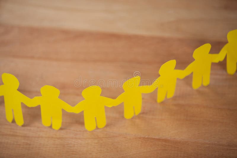 Paper Cut Outs Forming Human Chain Wooden Table Stock Photos - Free ...