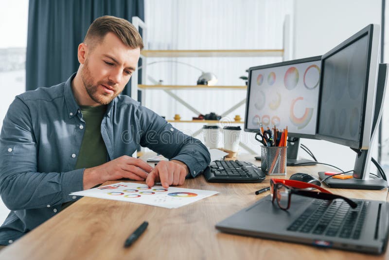 Paper with Different Colors. Male Designer Working in the Office by ...
