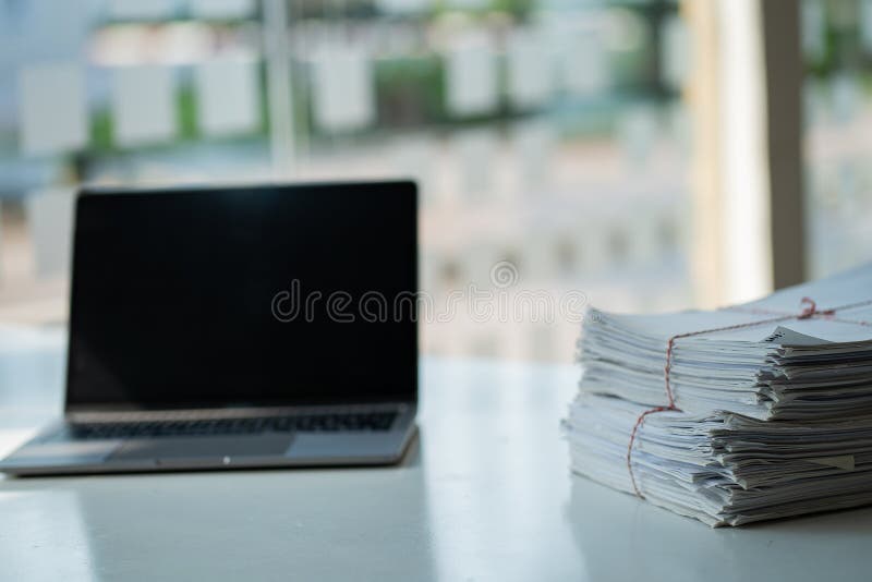Paper Documents Stacked on a Wooden Table at Work. Business Idea Laptop ...