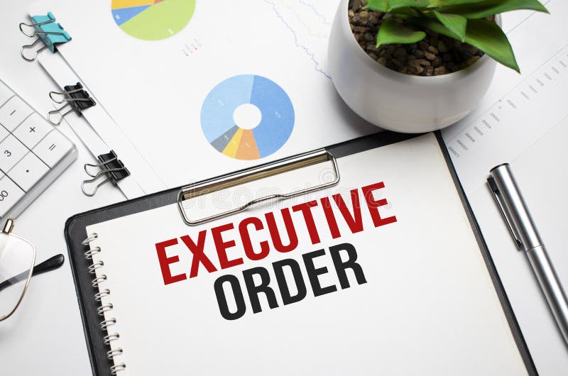 Paper with Executive Order on the Table, Calculator and Money Stock ...
