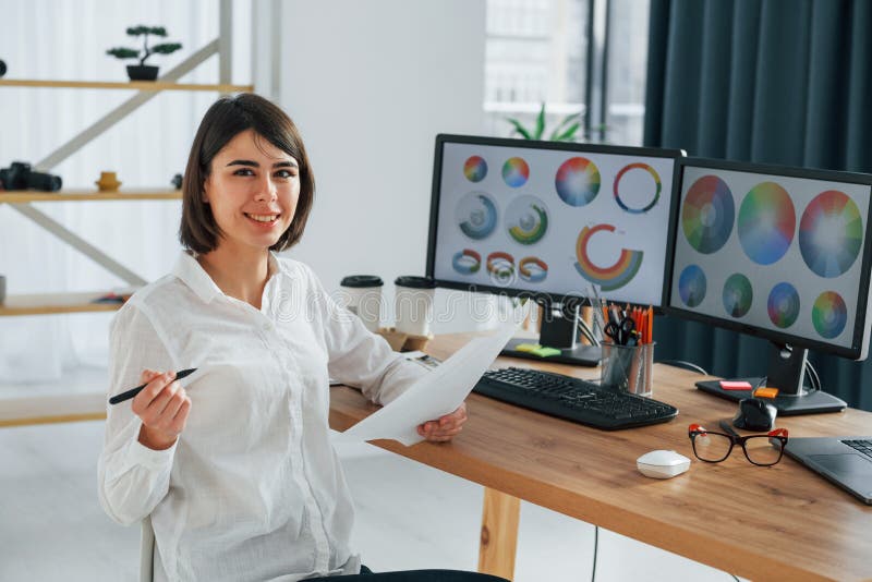 With Paper. Female Designer Working in the Office by Using PC Stock ...