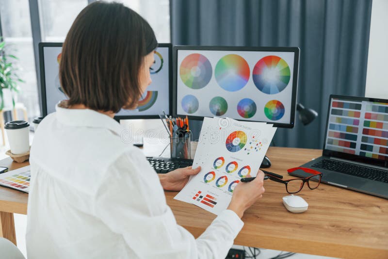 With Paper. Female Designer Working in the Office by Using PC Stock ...