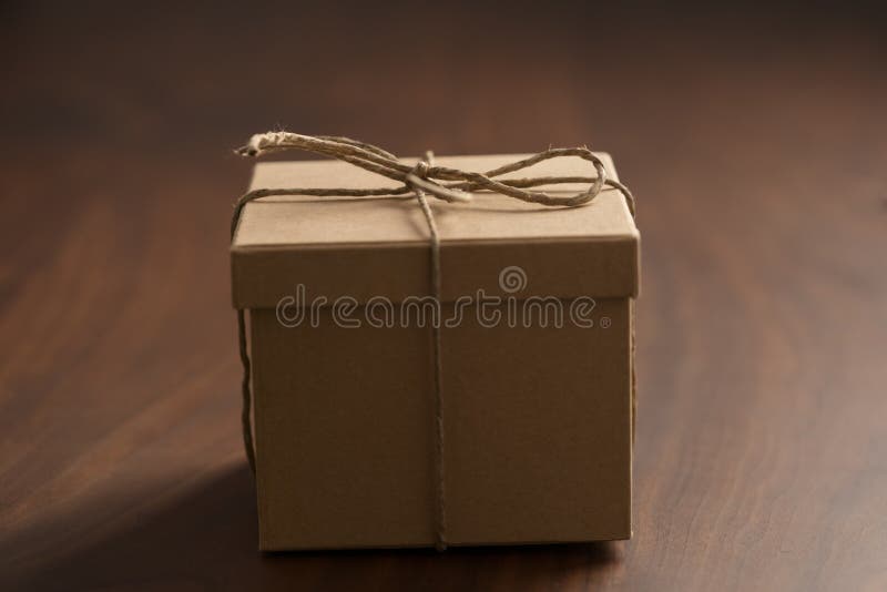 Paper Gift Box with Rope on Walnut Wood Table with Copy Space Stock ...
